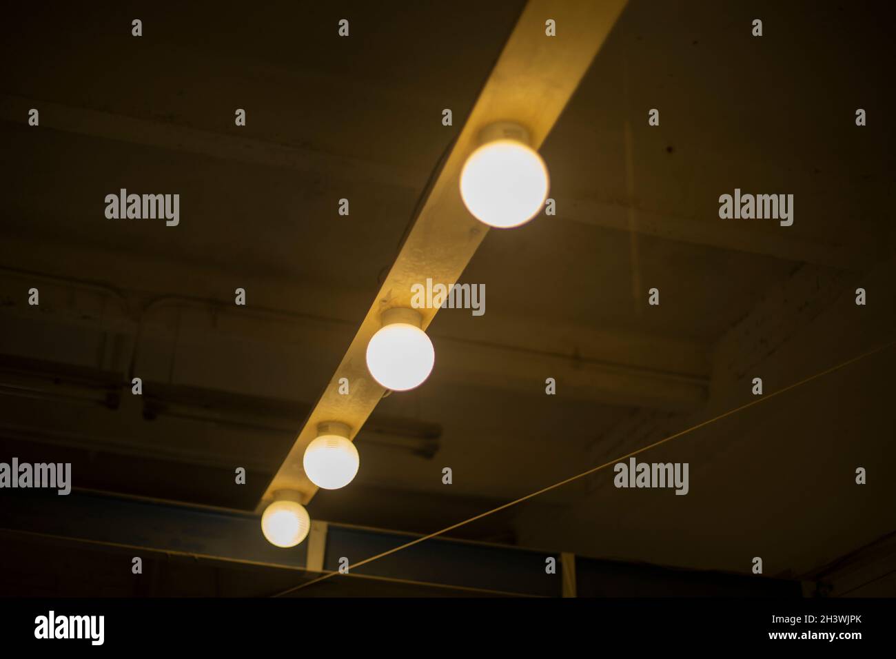 Four lamps in a row. Lamps under the ceiling. Round lamps in the ...