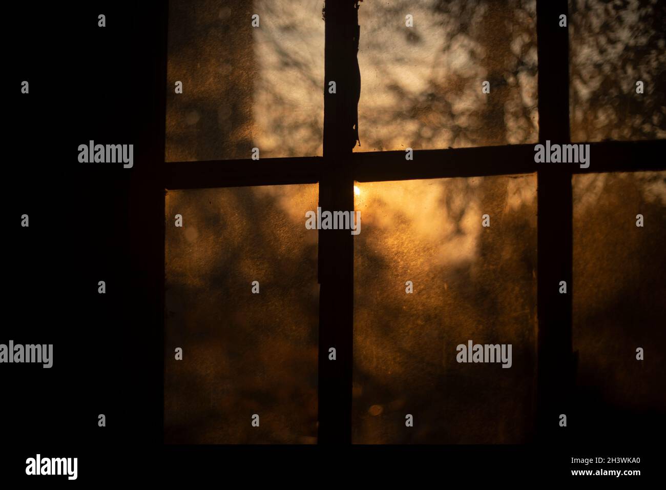 Window at dawn. Balcony in the sunlight. Gold color and dark window ...