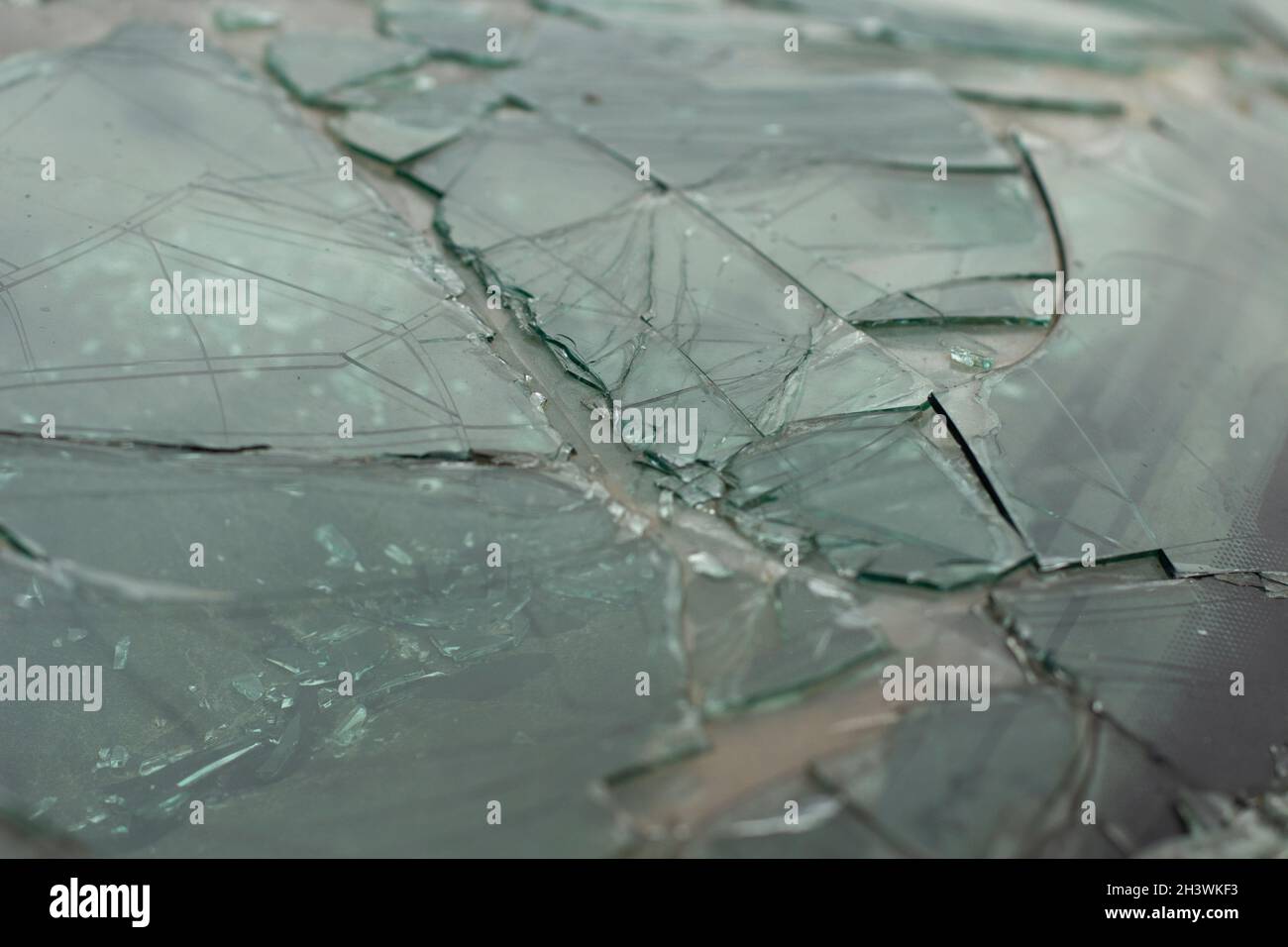 Broken glass in detail. Car windshield after the accident. Lots of ...