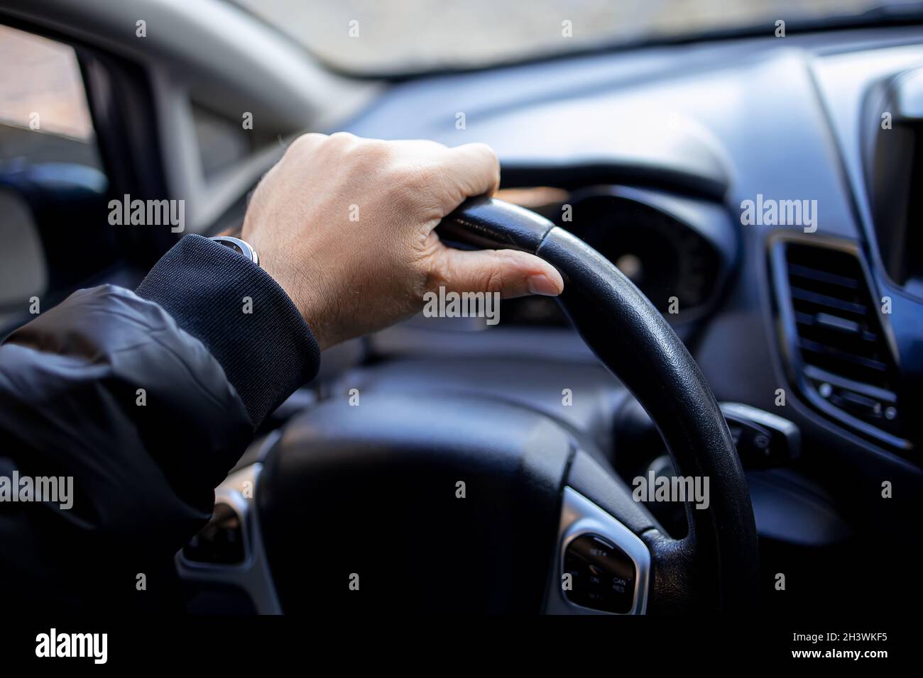 Mans hand steering wheel hi-res stock photography and images - Alamy
