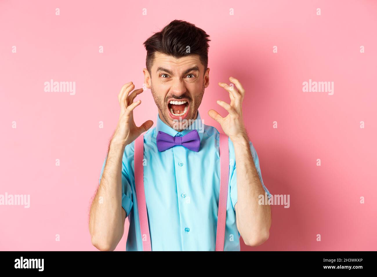 Frustrated young man losing temper, screaming and looking angry at ...