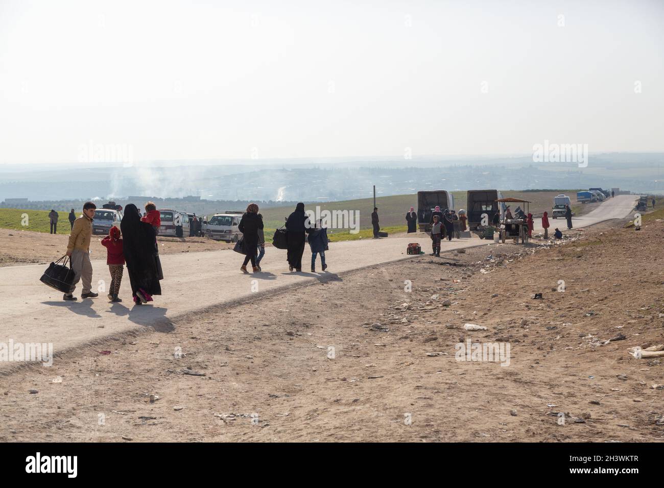 Syrian refugees are walking on the road. Syrian refugees returning to ...