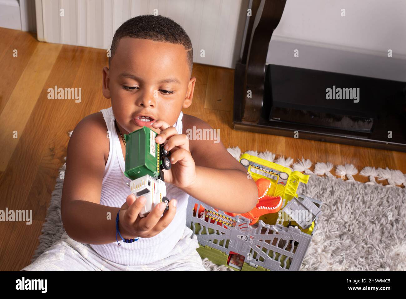 Preschool child at home age 4 or 5, playing with toy talking, talking ...