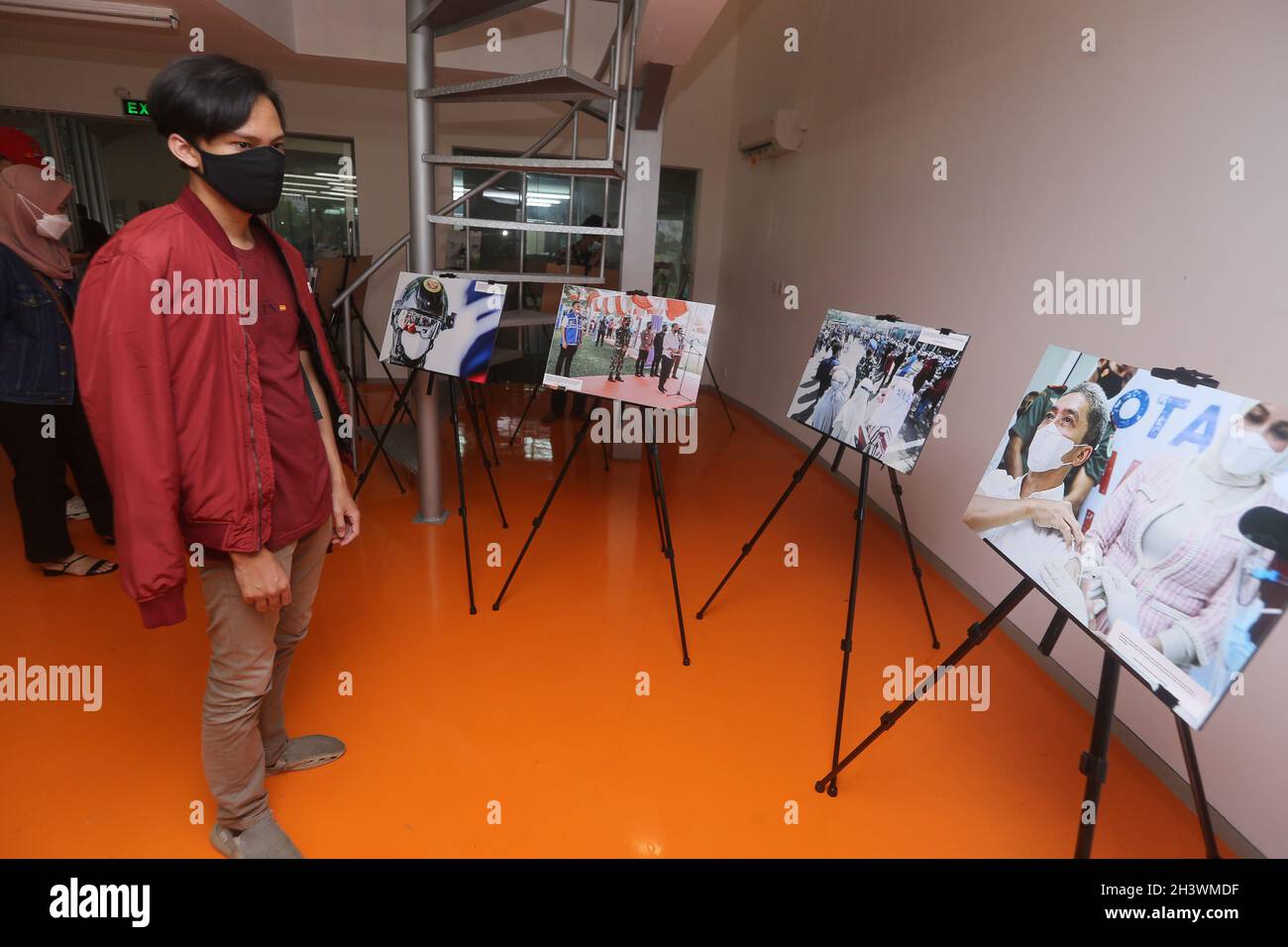 Bogor, Indonesia. 30th Oct, 2021. Visitors observe the photos displayed ...