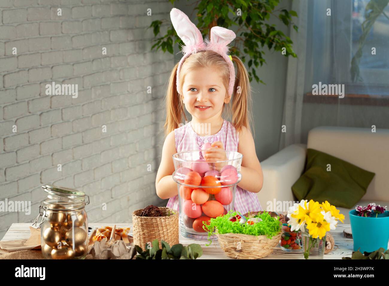 Happy little girl with bunny ears getting ready for Easter party Stock ...