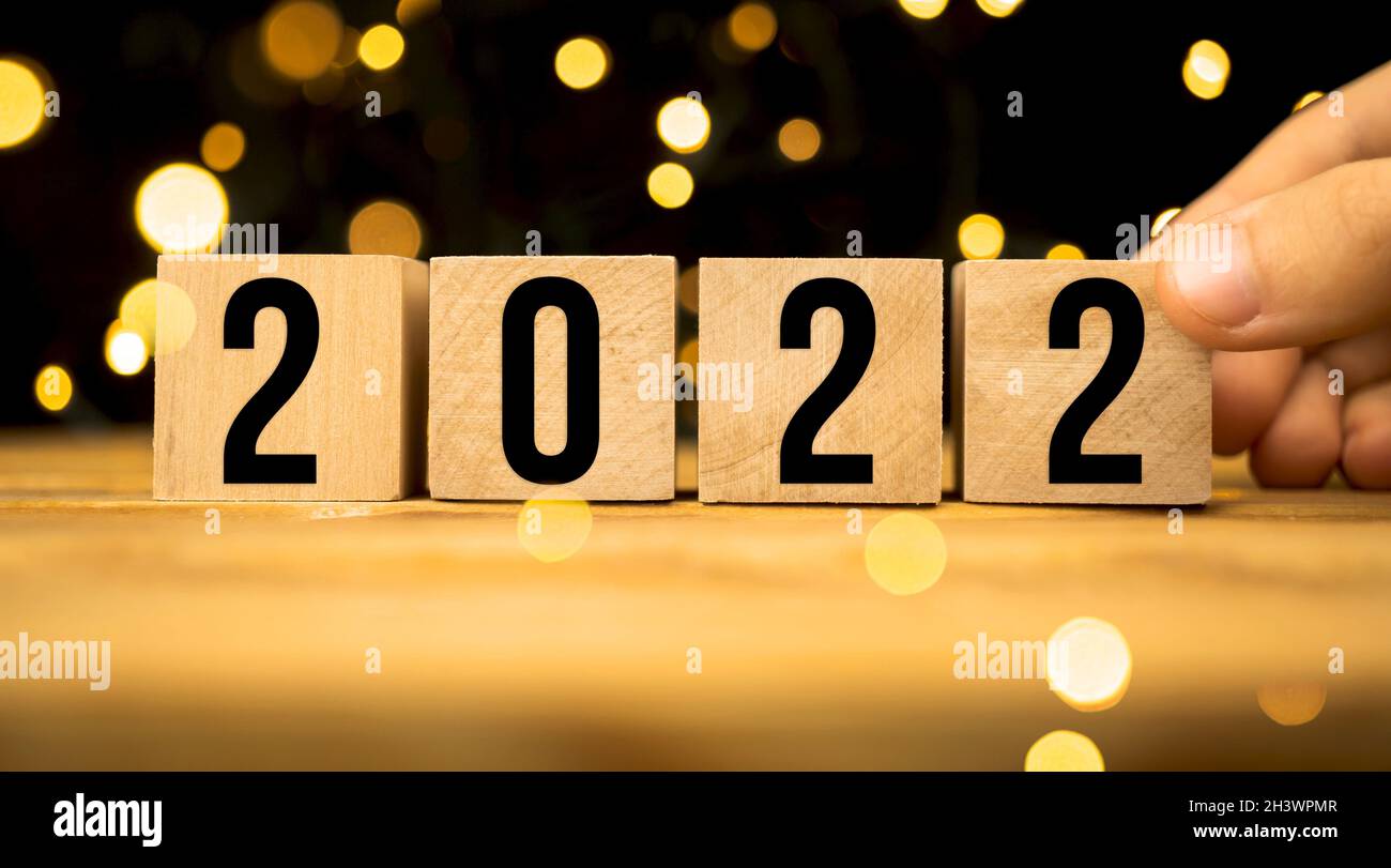 2022 New Year eve concept. Wooden blocks with number on table and bokeh ...