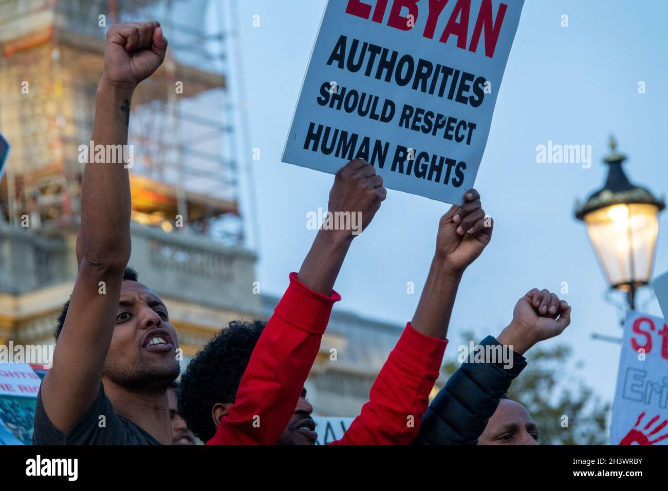 An activist chants angrily about abuse of human rights and waves his ...