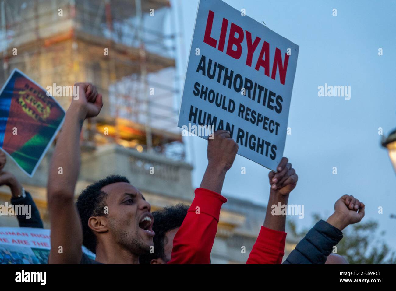 An activist chants angrily about abuse of human rights and waves his ...