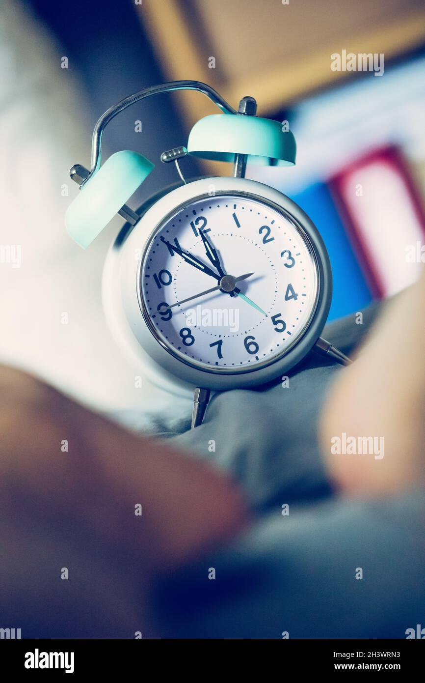 Alarm clock in the morning, legs Stock Photo - Alamy