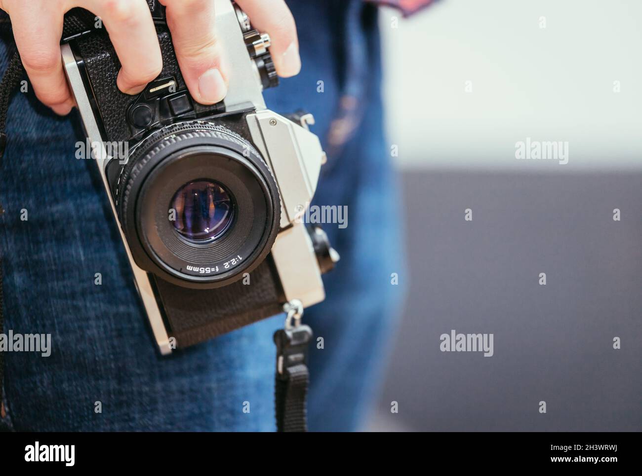 Photographer is holding a vintage camera, jeans and shirt Stock Photo ...