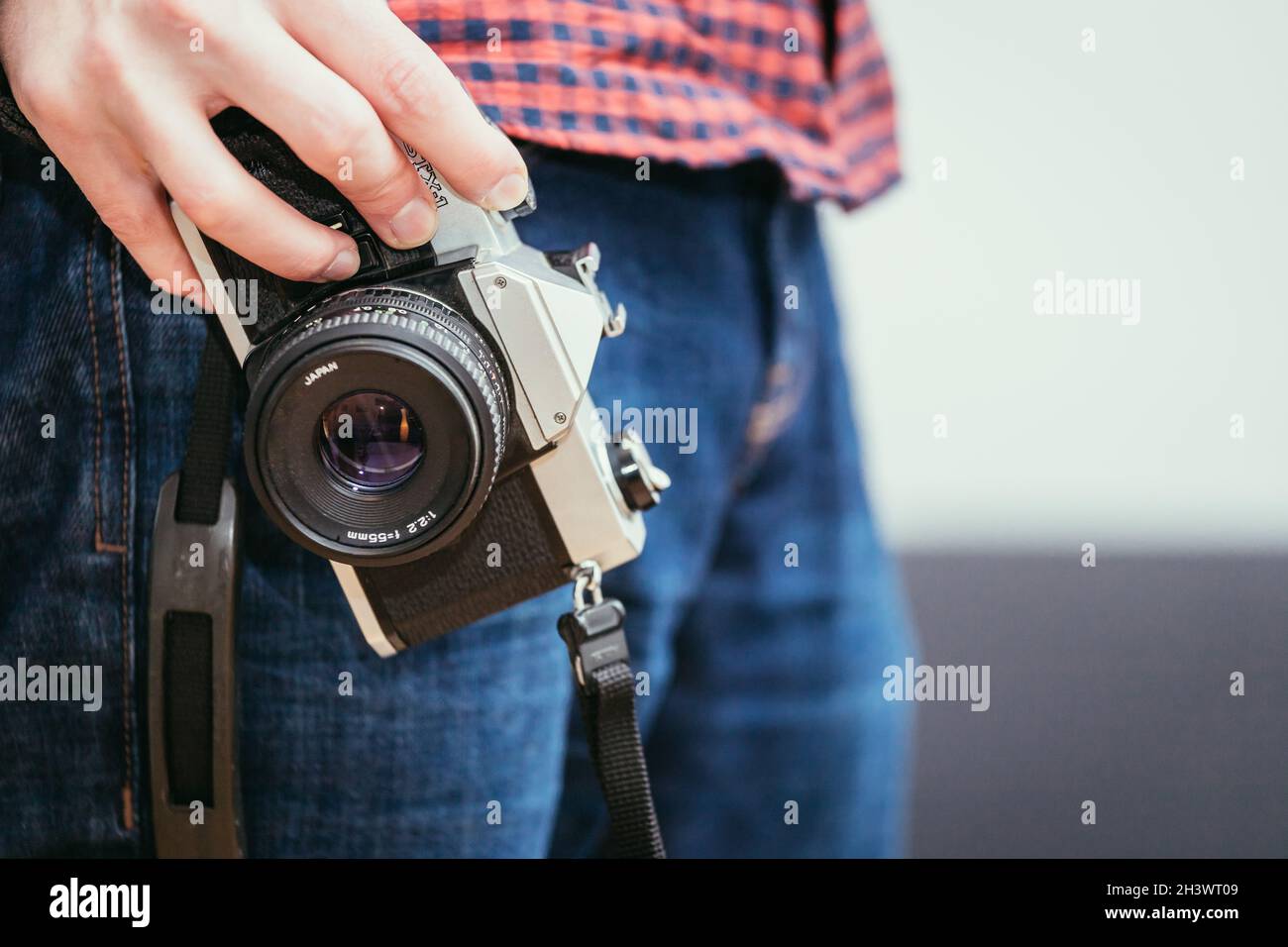 Photographer is holding a vintage camera, jeans and shirt Stock Photo ...
