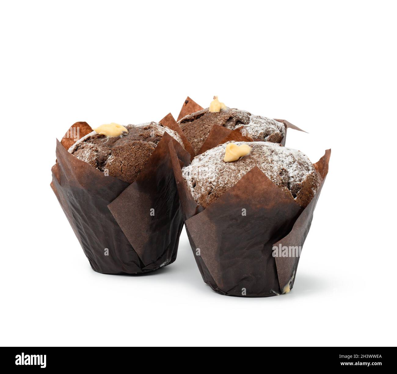 Baked chocolate muffins with cream wrapped in brown paper Stock Photo ...