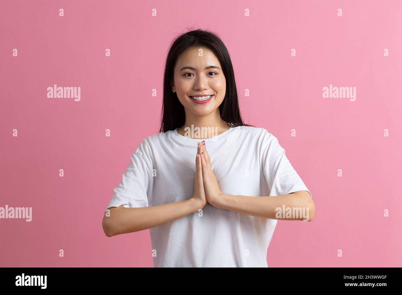 Namaste Portrait of asian woman holding palms together and bowing in ...