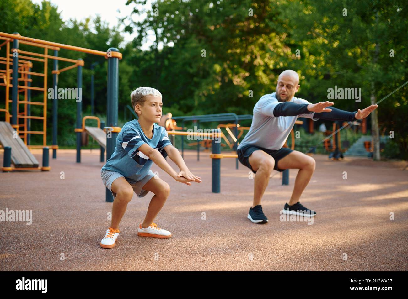 Dad and son doing exercise, sport training Stock Photo - Alamy