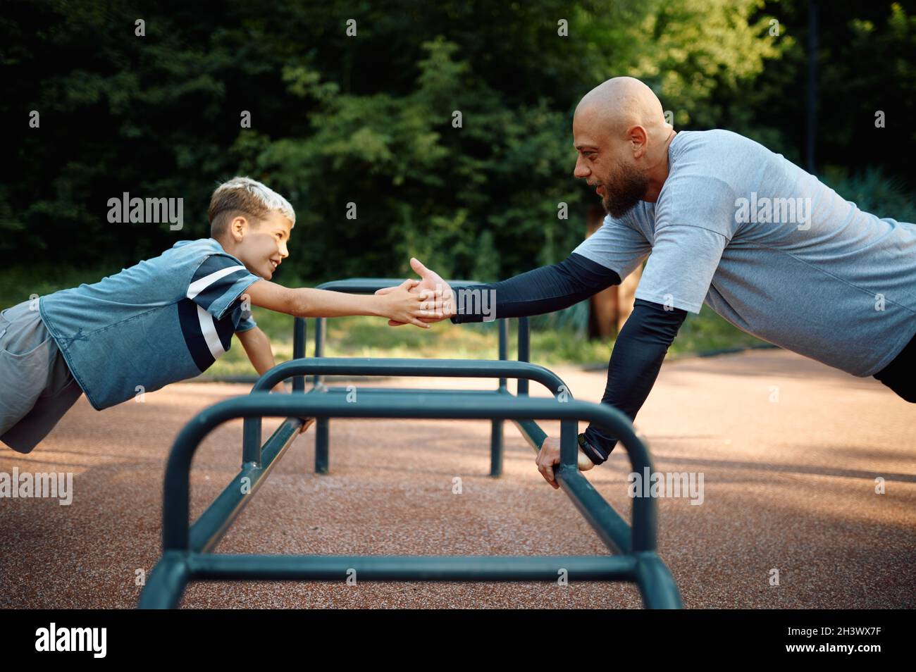 Father and boy, push-up exercise on playground Stock Photo - Alamy