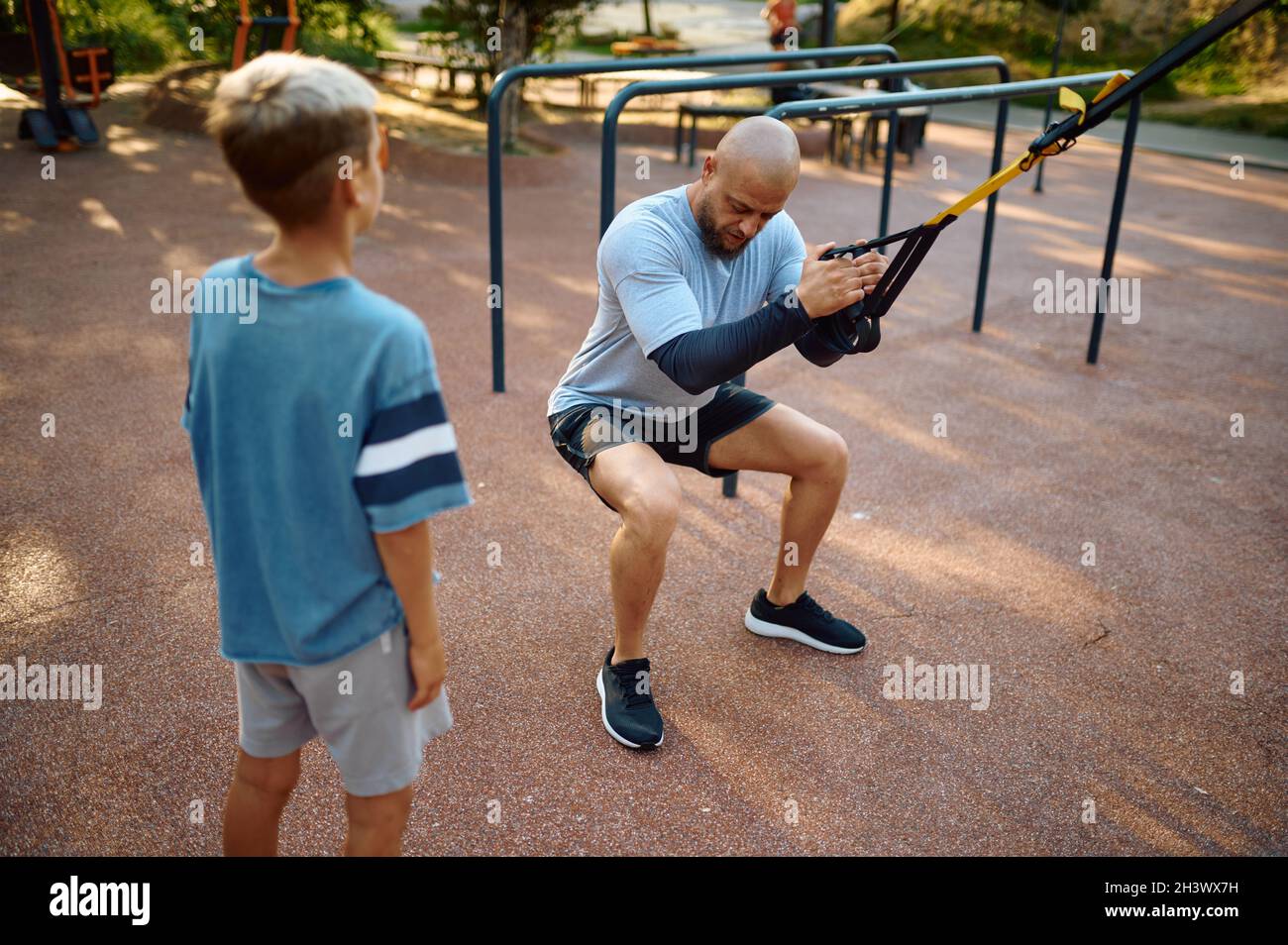 Father and boy, exercise with ropes on playground Stock Photo - Alamy