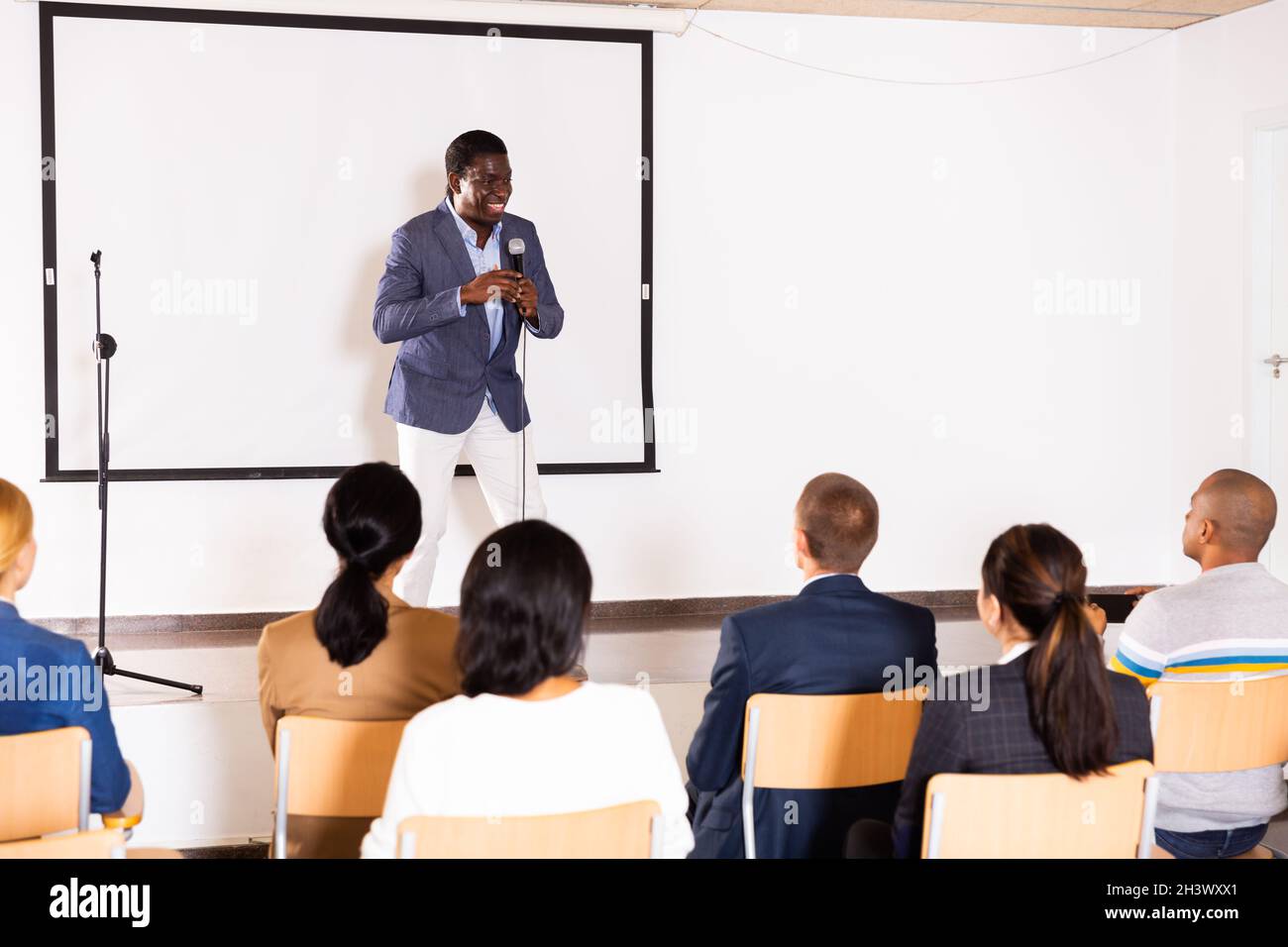 Young emotional male coach giving motivational speech Stock Photo - Alamy