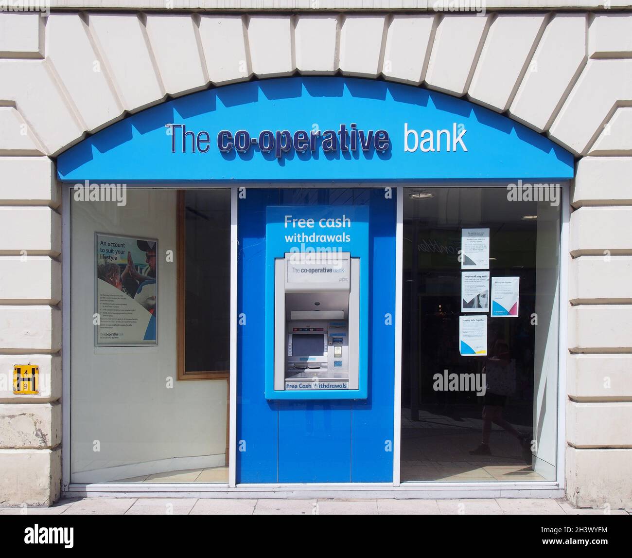 Sign and logo above the entrance of the co-operative bank on commercial ...
