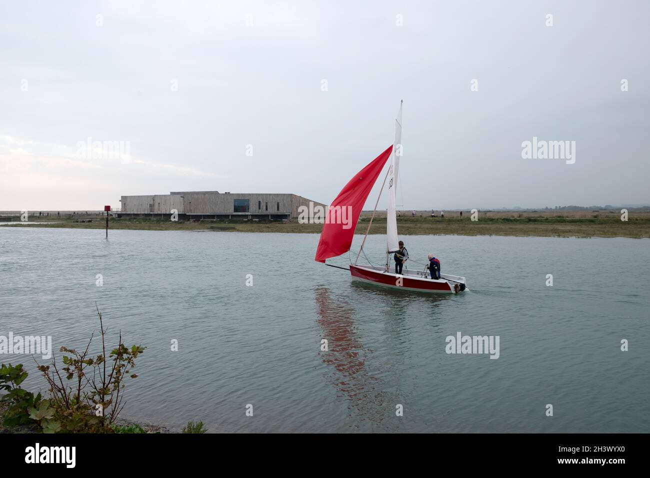 Small boat sailboat sailing past the Rye Discovery Centre on the Rother ...