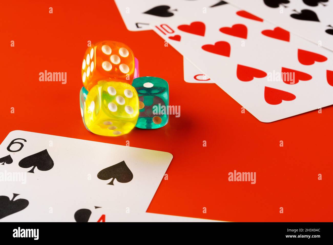Dice and cards scattered on table close up Stock Photo - Alamy