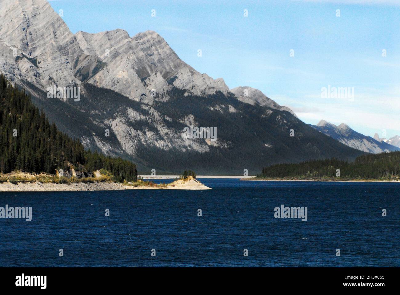 A beautiful panoramic landscape of a deep blue lake contrasting with ...