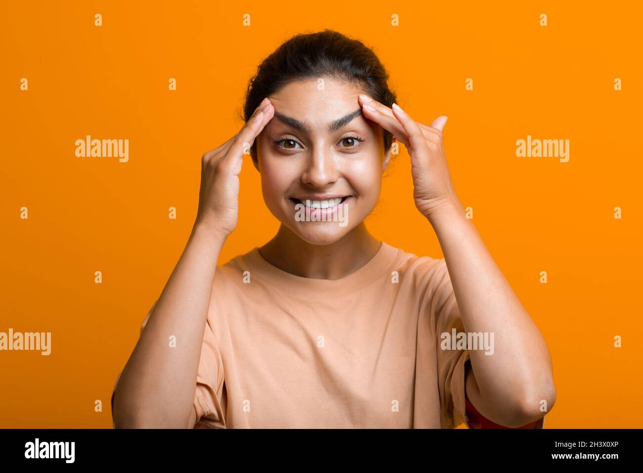 Close up portrait of young indian american woman doing facebuilding ...