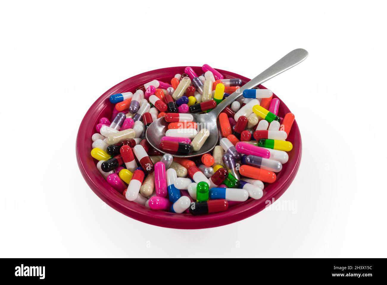 Bowl of pills and capsules with white background Stock Photo - Alamy
