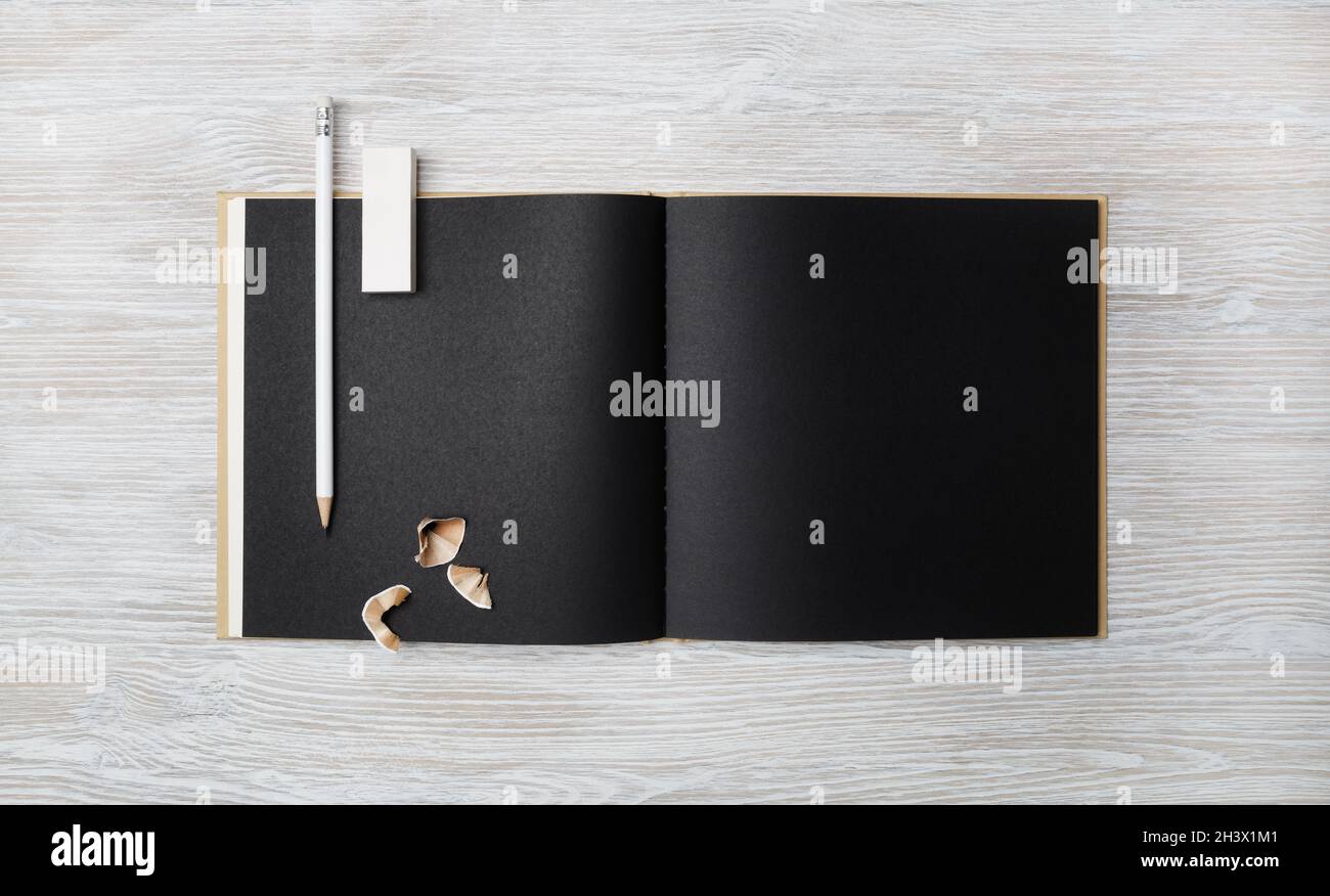 Black booklet, pencil, eraser Stock Photo - Alamy