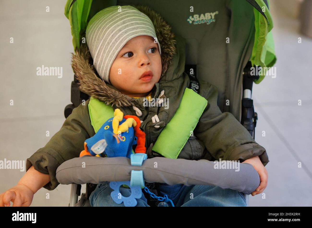 POZNAN, POLAND - Apr 23, 2015: A view of a Polish male kid sitting in a ...