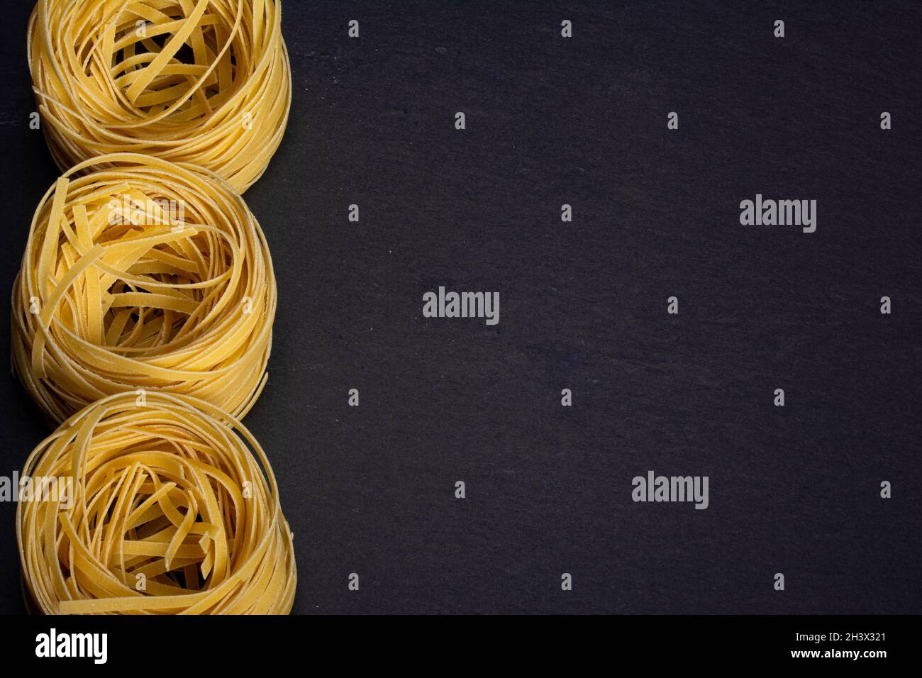 Assorted varieties of pasta wallpaper. Mix macaroni, spaghetti on blue ...
