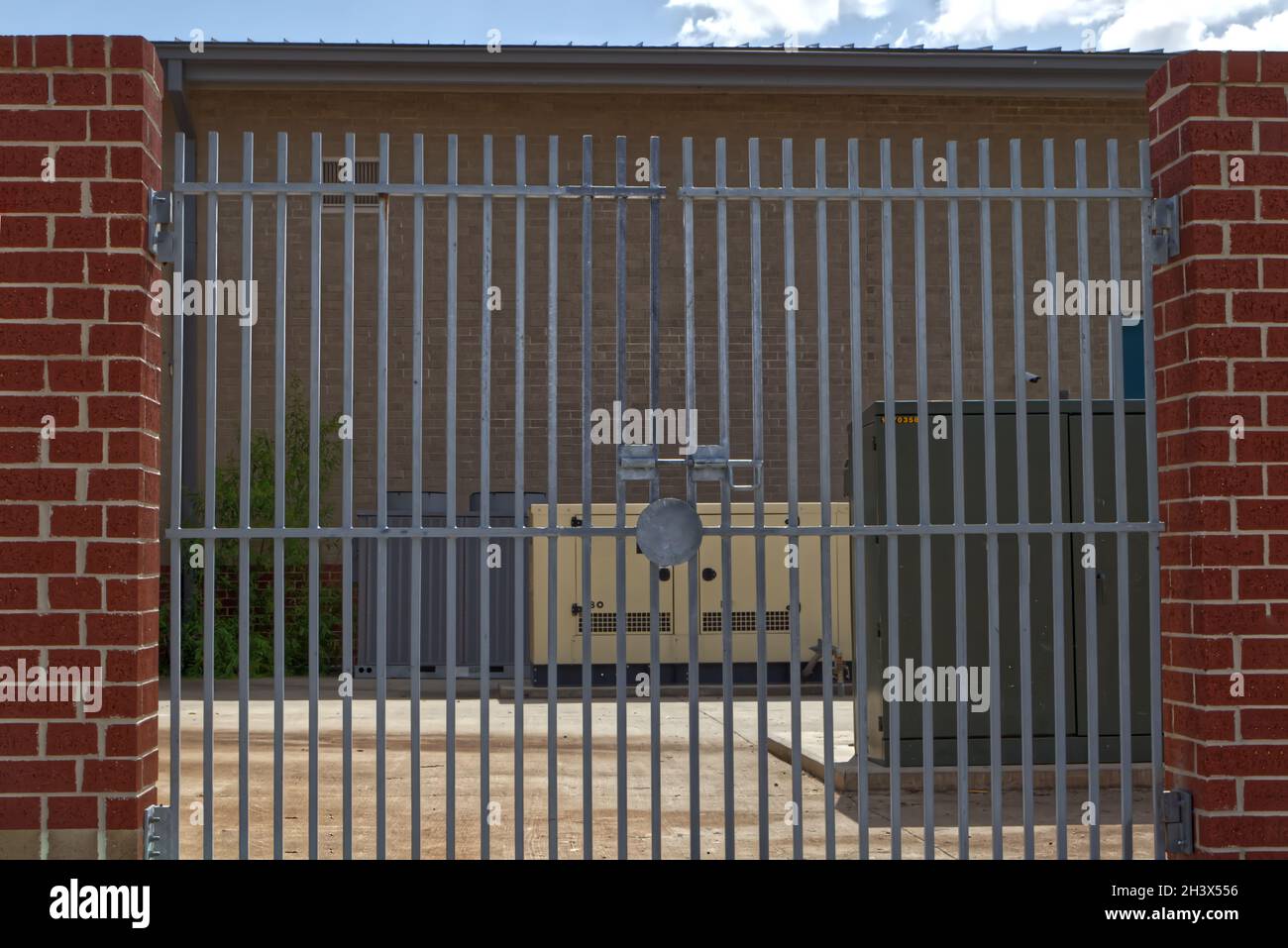 A locked security gate industrial machines and building in rural ...