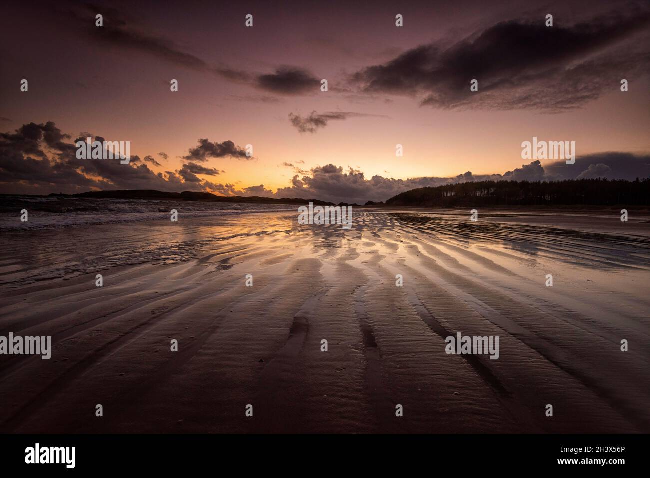 Sunset reflections at Traeth Llanddwyn, Anglesey Wales UK Stock Photo ...