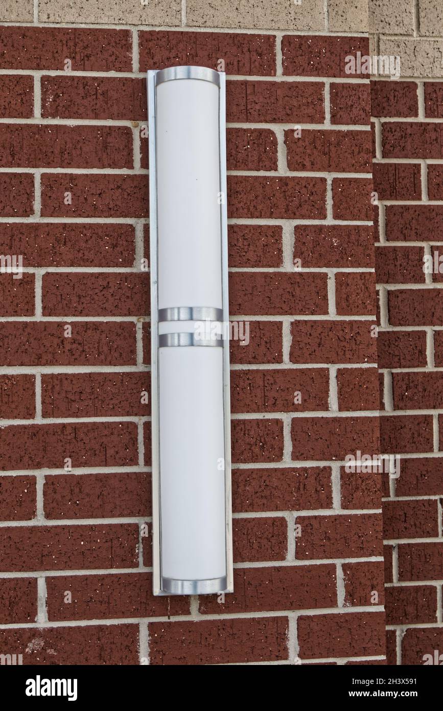 An LED light panel on a brick wall background texture Stock Photo - Alamy