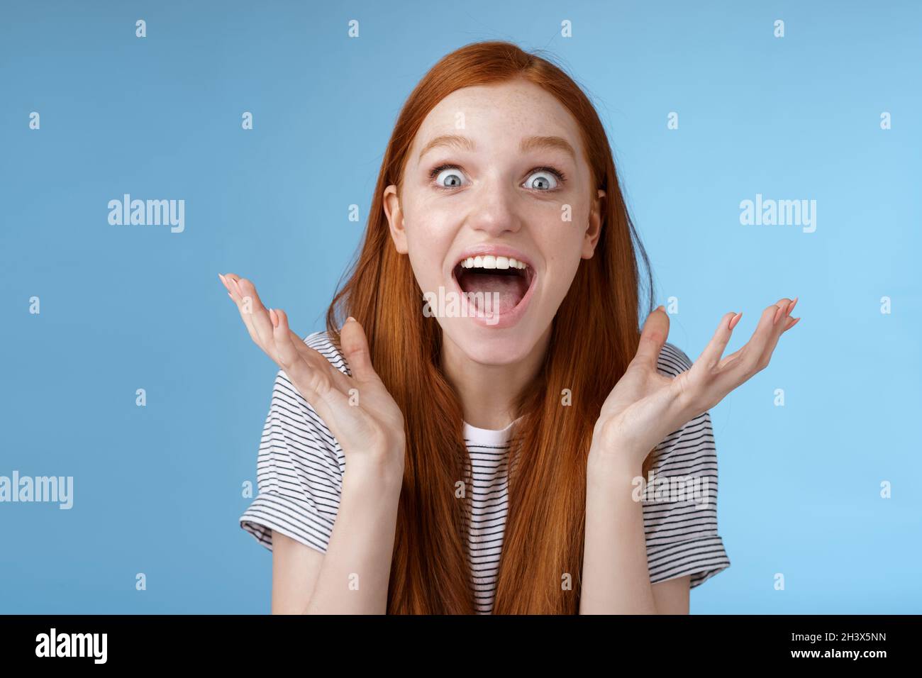 Excited overwhelmed young attractive female redhead fan go nuts ...
