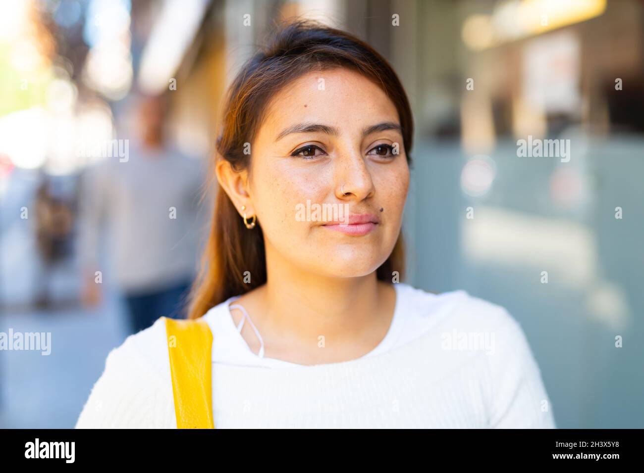 Portrait of beautiful smiling young Latin American girl looking forward ...