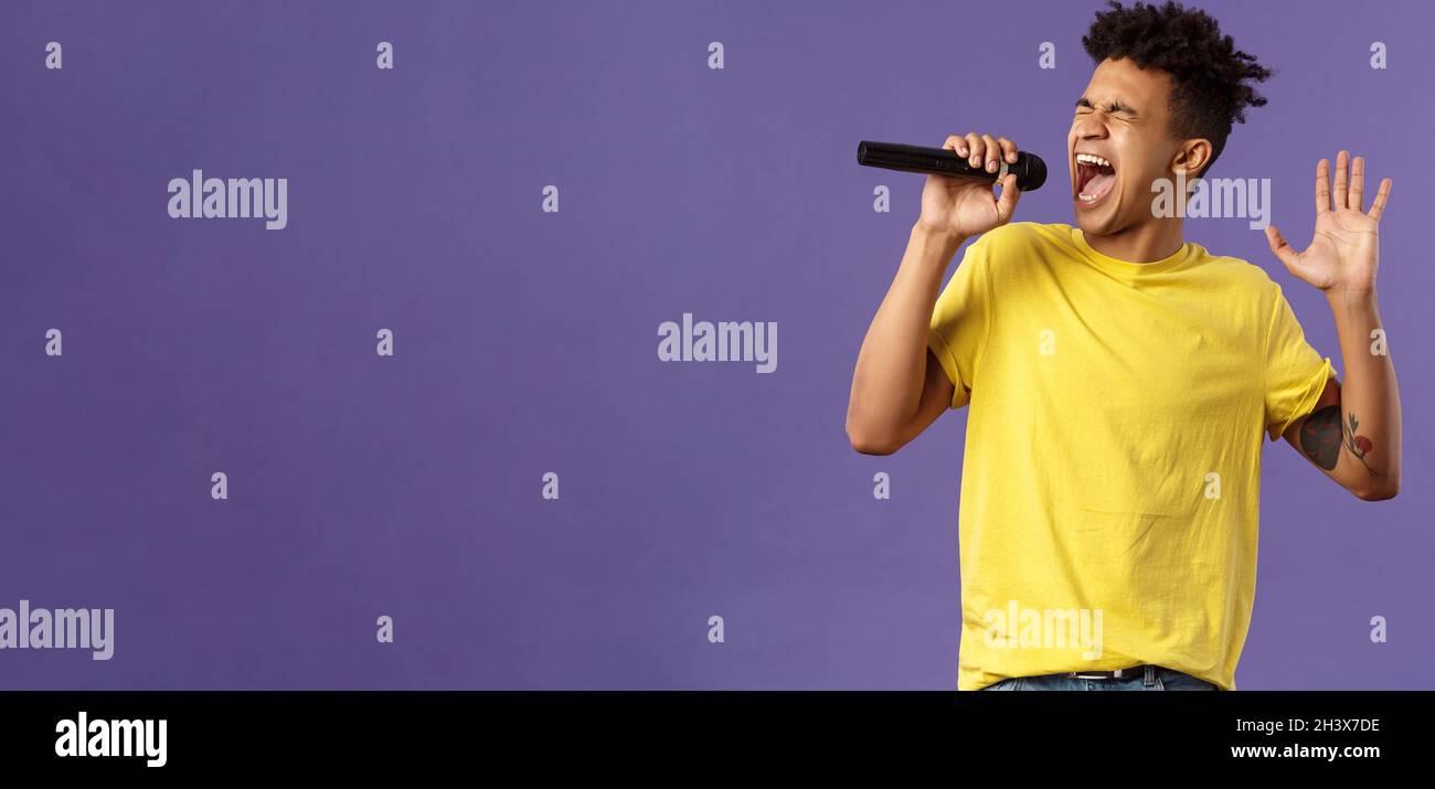 Portrait of passionate carefree young hispanic singer with dreads and ...