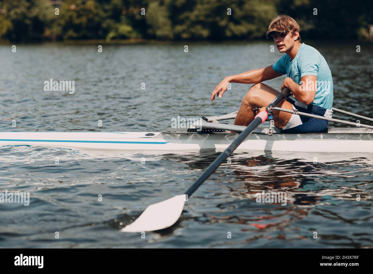 Sportsman single scull man rower rowing on boat Stock Photo - Alamy