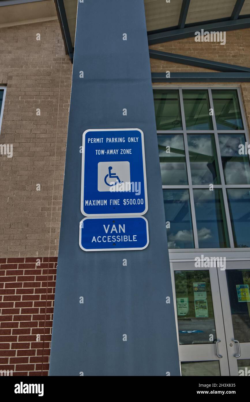 Handicap sign on a post and modern building in Georgia Stock Photo - Alamy