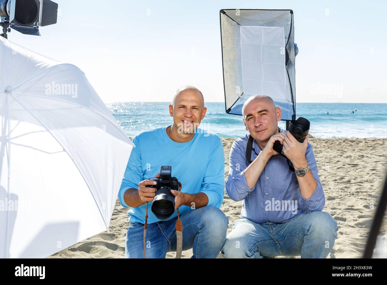 Portrait of two photographers on seaside Stock Photo - Alamy