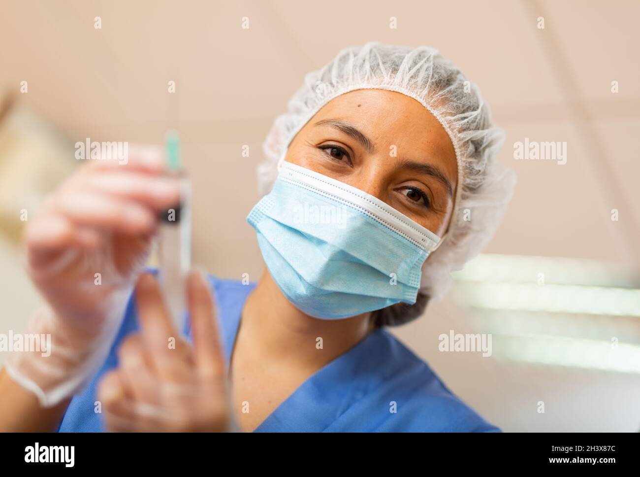 Confident woman doctor holding syringe for injection Stock Photo - Alamy
