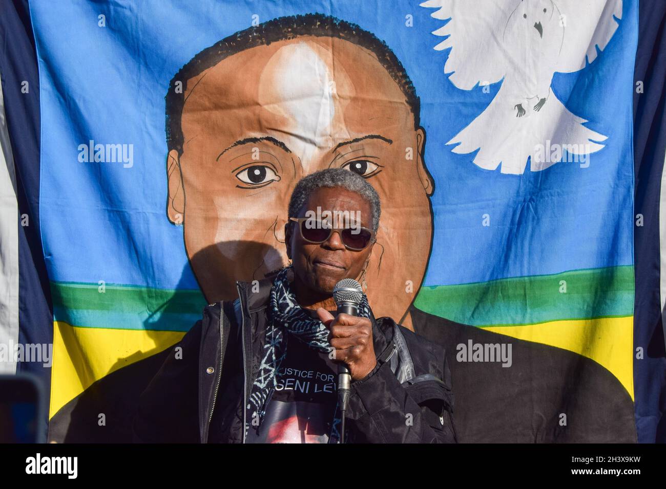 London, UK. 30th Oct, 2021. A protester standing in front of a banner ...