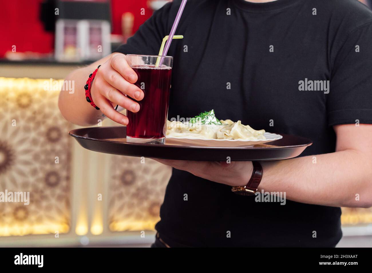 Waiter serving an order, refreshing drink or juice Stock Photo - Alamy