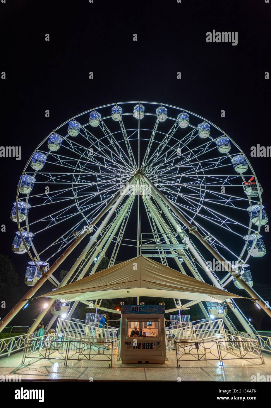 ferris wheel illuminated at night, fairground ride lit up in the night ...