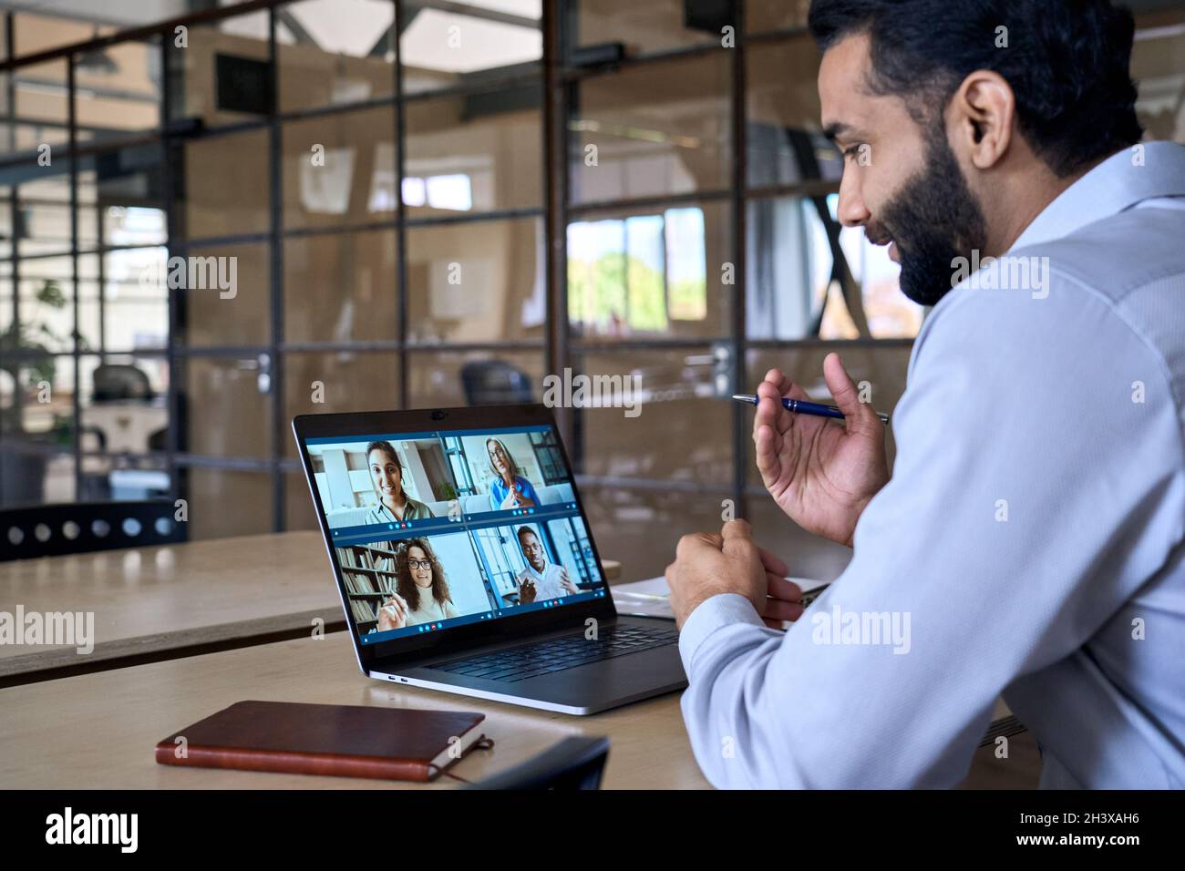 Indian smiling executive ceo businessman having working video call in ...