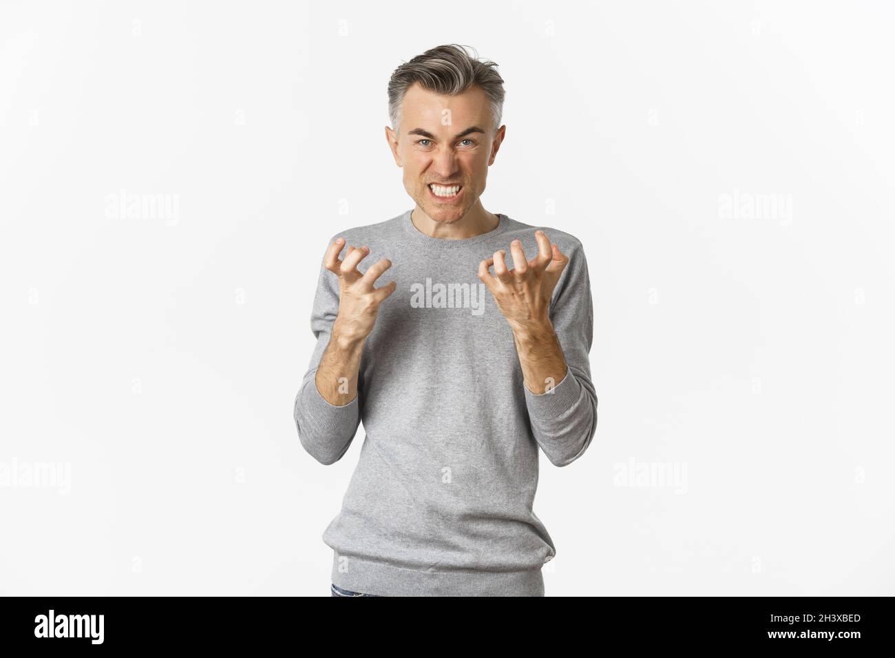 Image of angry middle-aged man cursing someone, looking mad and ...