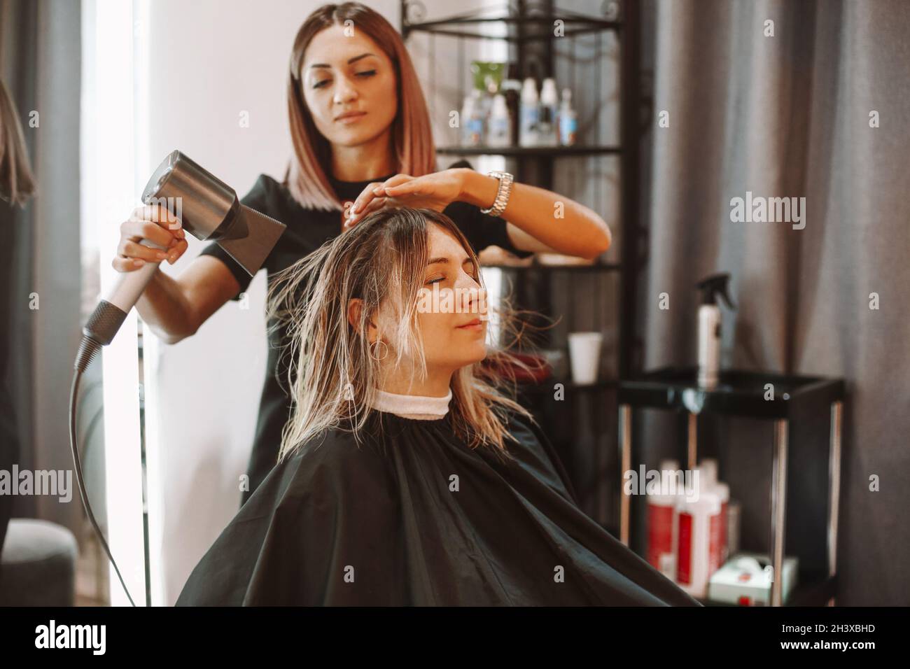 Professional woman hairdresser making creative hi-res stock photography ...
