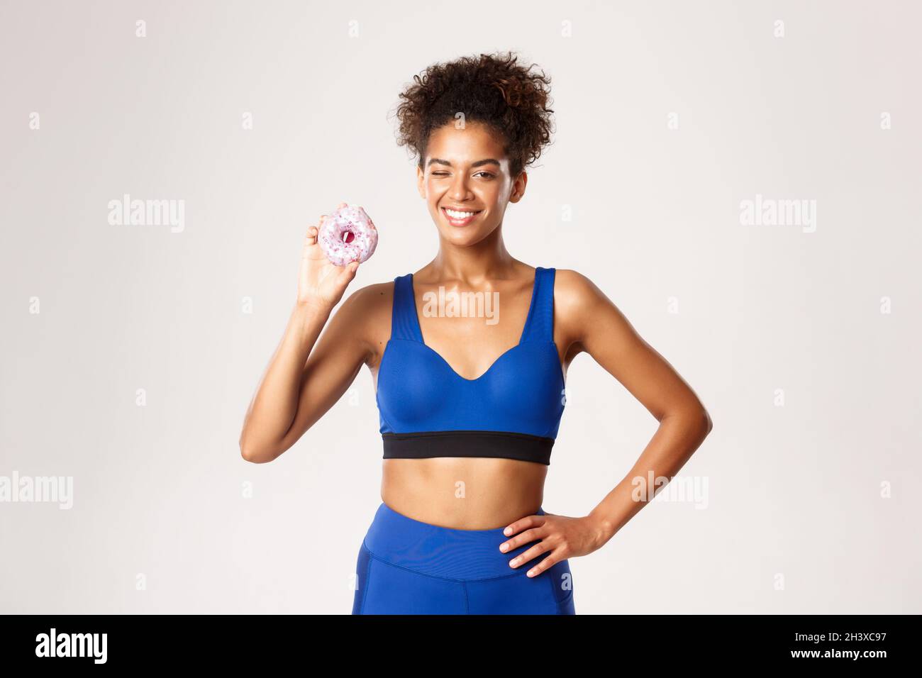 Cheerful fit african-american fitness woman in blue uniform, winking ...
