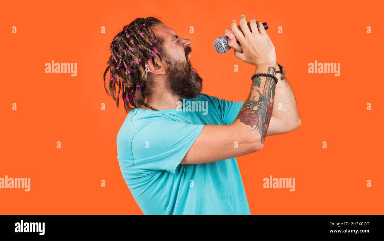Solo singer. Karaoke Man singing with microphone. Bearded male sing ...
