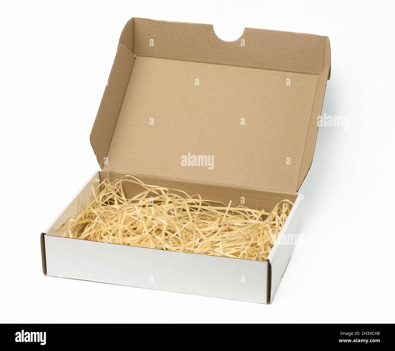 Rectangular open corrugated paper box with sawdust inside. Packaging ...