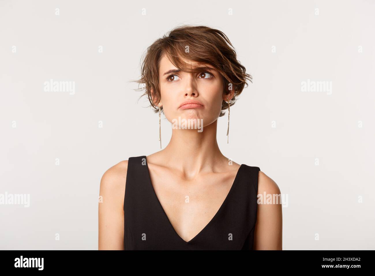 Close-up of sad gloomy girl frowning and sulking, looking left ...